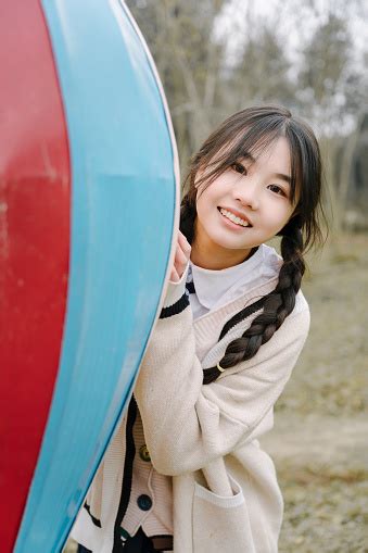A Beautiful Asian Girl Next To A Hotair Balloon On A Sunny Day Stock