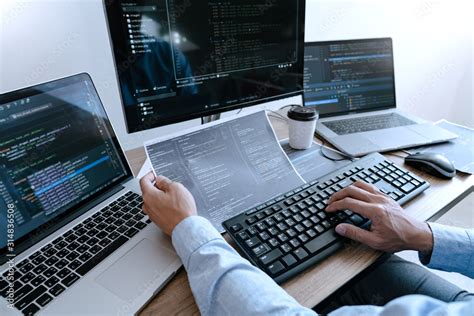 Programmer Working On Computer In It Office Typing Data Coding In Software And Checking Code On