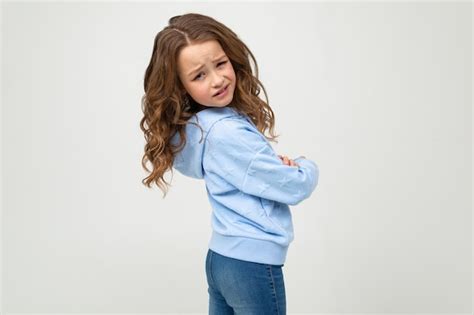 Premium Photo Offended Girl In A Blue Hoodie Crossed Her Arms On A