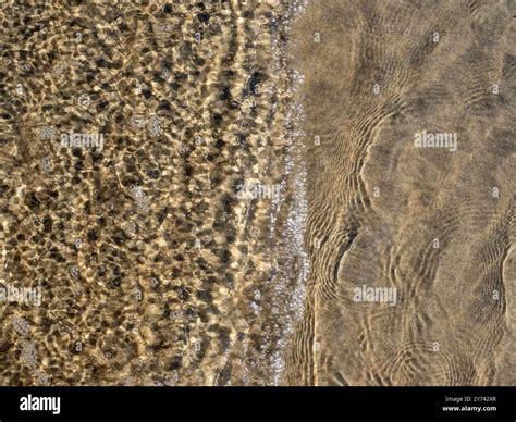 Rippled Shallow Water Surface With Visible Beach Sand Texture Stock