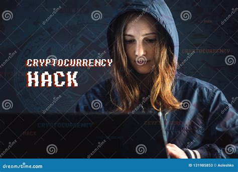Girl Hacker In A Hood Typing Program Code While Committing A Cybercrime Hacking A System On The