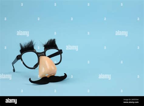 Funny Mask With Fake Mustache Nose And Glasses On Light Blue