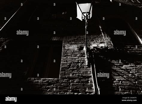A Low Angle Of A Street Light And Electricity Cables On A Stone Brick