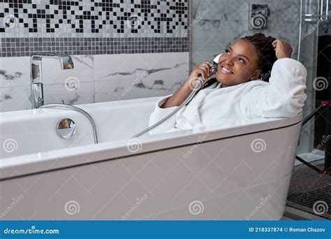 Nice Young Woman With Perfect Dark Skin Sits Inside Of Bathtub Poses