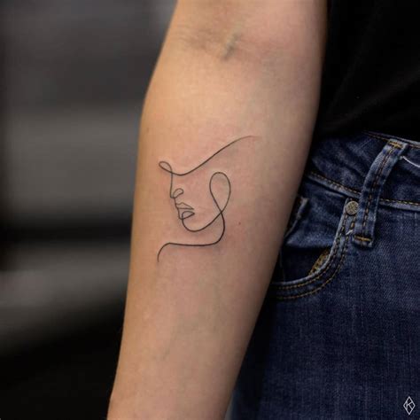 One Line Face Tattooed On The Inner Forearm