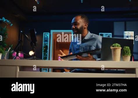 Content Creator In Dimly Lit Apartment Studio Films Keyboard And Mouse Set Review For Online