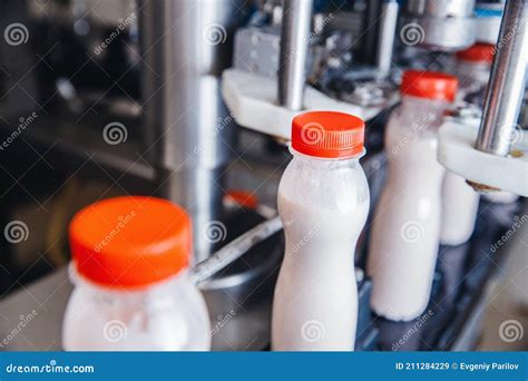 Dairy Production Bottle Of Yoghurt On Automated Conveyor Line Process Of Milk Filling And