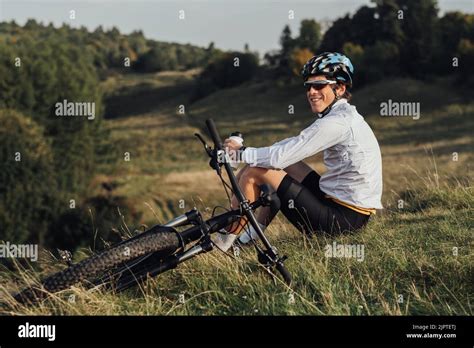 Professional Male Cyclist Drinking Water From Bottle Man Sitting Near