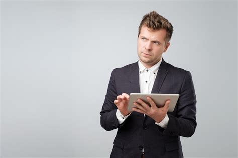 Premium Photo Examining New Gadget Confident Young Handsome Man In