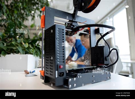 Two Men Architects Using 3d Printer In Office And Projecting House Drawing Blueprints Stock