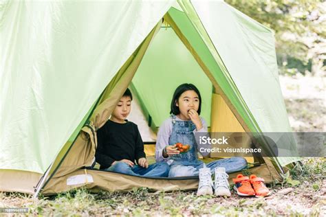 Japanese Brother And Sister Spending Time Together In Tent While