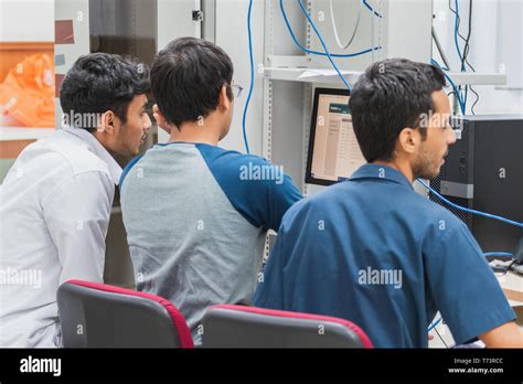 Group Of Indian University Computer Engineering Students Working And Discuss Together To Finish