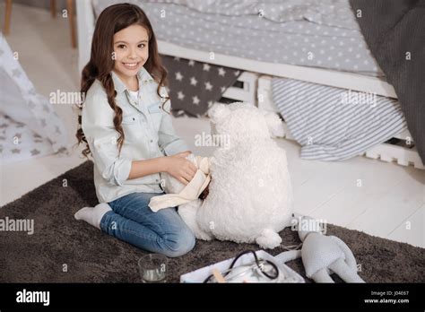 Charming Girl Bandaging Toy At Home Stock Photo Alamy