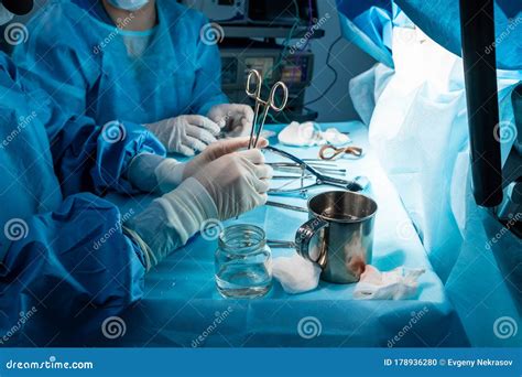 A Group Of Surgeons Performing Minimally Invasive Surgery On The Patient`s Anus Using Surgical