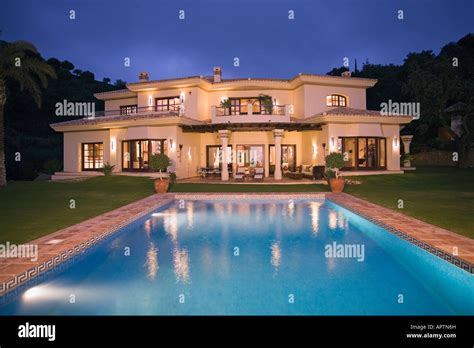 Modern Spanish Villa With Swimming Pool Rear Facade At Dusk Stock Photo Royalty Free Image