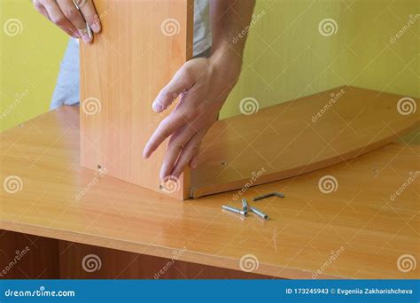 Man Is Collecting Parts Of Computer Table Screwing Shelf Screwdriver