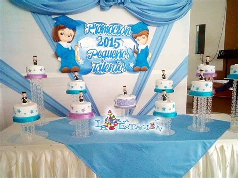 A Table Topped With Lots Of Cakes And Cupcakes On Top Of A Blue Table Cloth