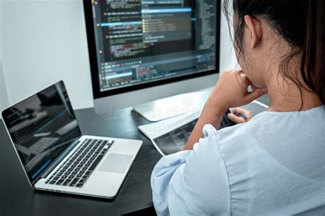 female programmer working in software javascript computer in it office