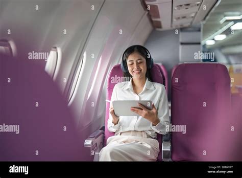 Plane Passenger Business Woman Working In Airplane Cabin During Flight With In Flight Wifi