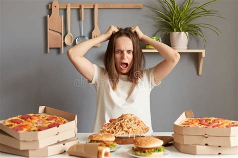 Portrait Of Crazy Irritated Shocked Woman Wearing White T Shirt Sitting