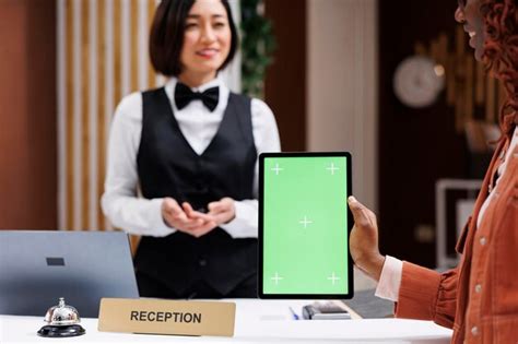 Premium Photo Guest Using Greenscreen At Check In Talking To