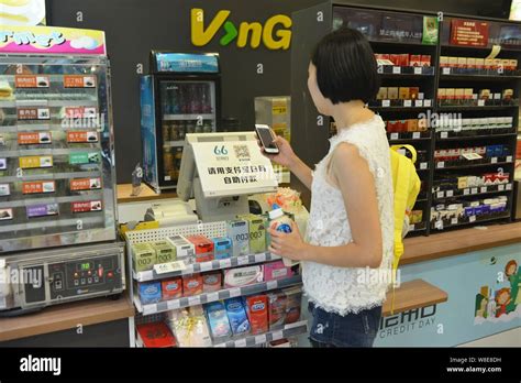 A Customer Scans A QR Code Of Alipay A Mobile Payment Service Of Alibaba Group To Pay For