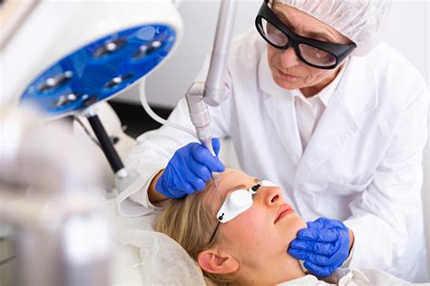 젊은 여성에게 레이저 표면 재포장을 수행하는 집중된 미용사 레이저에 대한 스톡 사진 및 기타 이미지 레이저 35 39세 40 44세 Istock