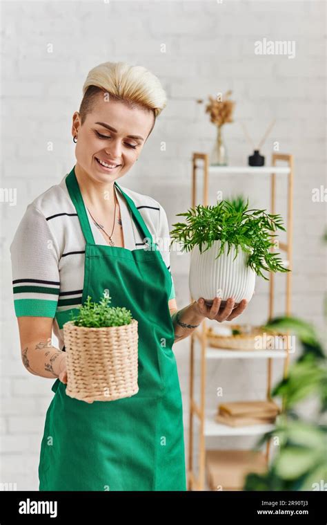 Plant Lover Eco Conscious Lifestyle Pleased Tattooed Woman With Radiant Smile Holding