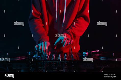 Hands Of Dj Mixing Vinyl Records With Sound Mixer In Close Up
