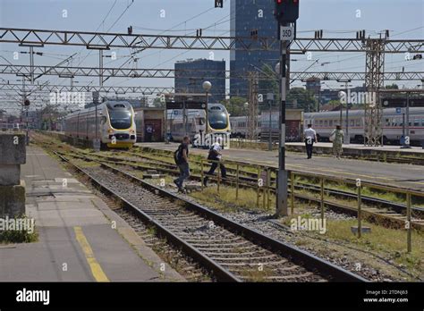 People Crossing The Railway Tracks To Catch A Train At Glavni Kolodvor
