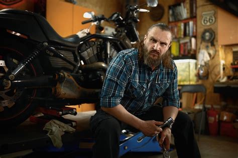 Premium Photo Portrait Of Mature Bearded Biker Looking At Camera