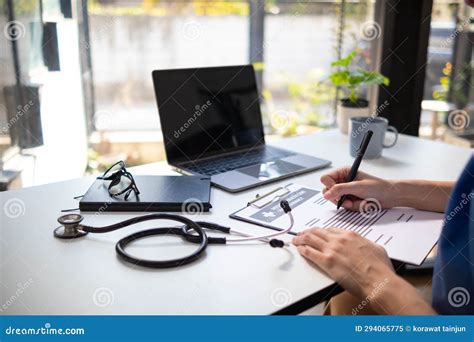 Female Doctor Is Reviewing Documents To Review And Diagnose Illness And Female Doctor Has