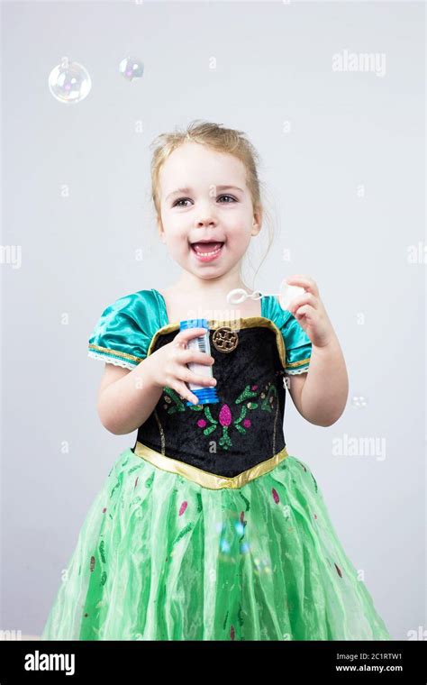 Beautiful Little Blonde Girl Has Happy Fun Cheerful Smiling Face Pink