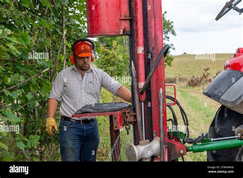 Fencing Contrator With Tools Of His Trade Erecting A Wire Netting