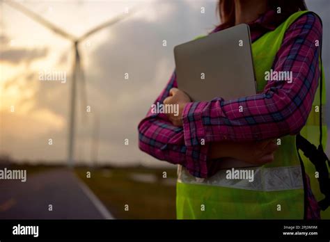 Asian Woman Working With Laptop At Renewable Energy Farm Female Inspector Controlling