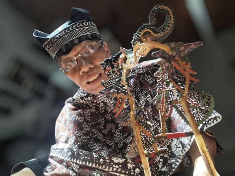 The Man Wearing Javanese Dresses Smiling With His Puppets Stock Image Image Of Wearing