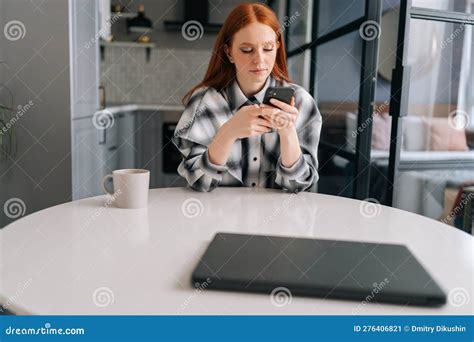 Portrait Of Confident Redhead Female Remote Employee Freelancer Sitting