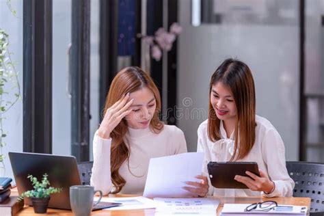 Two Young Asian Businesswomen Discussing A New Idea Presentation