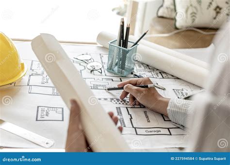 The Architect Wrote On The Blueprints To Modify The Design After