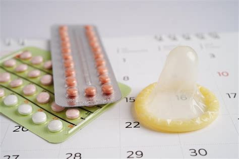 Premium Photo Pregnancy Test With Birth Control Pills And Condom For