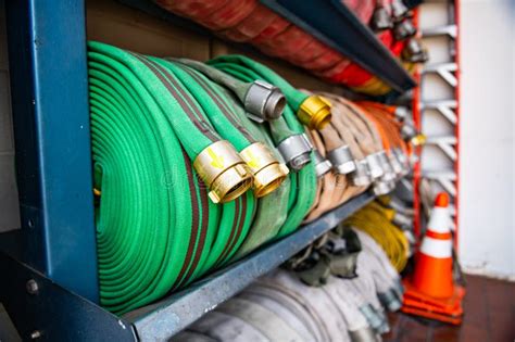 Fire Hoses Of Different Colors Are Stacked In Rows On A Fire Rack Stock