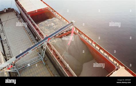 Grain Loading In Hold Of Bulk Carrier Ship With Elevator Crane Closeup