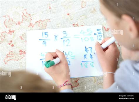 Girls Doing Maths Math Lying On Floor Writing On Whiteboard With Pens