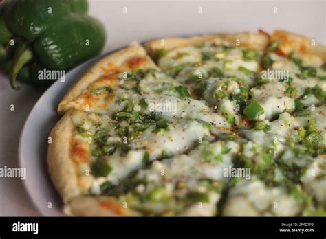 Home Baked Veg Pizza With Cheese And Capsicum Shot On White Background