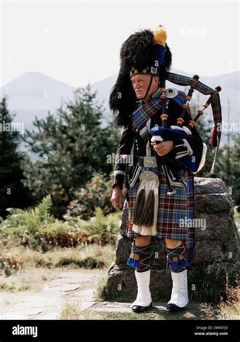 A Scottish Man In Traditional Tartan Kilt Dress With Bagpipes Scotland