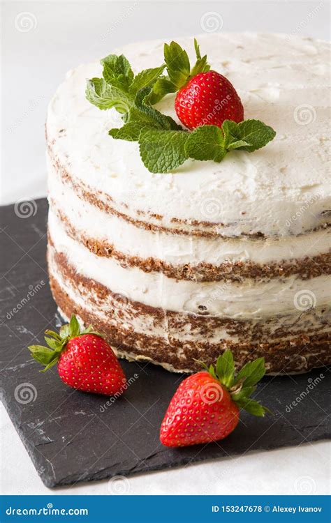 Delicious White Cream Icing Cake With Strawberry On The Black Board