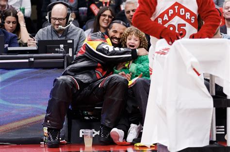 Drake And Son Adonis Sit Courtside At Toronto Raptors Basketball Game