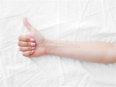 Female Hand Pulling White Sheets In Ecstasy Orgasm Concept Of Passion