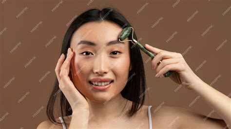 Premium Photo Charming Asian Lady Making Lymphatic Drainage Facial