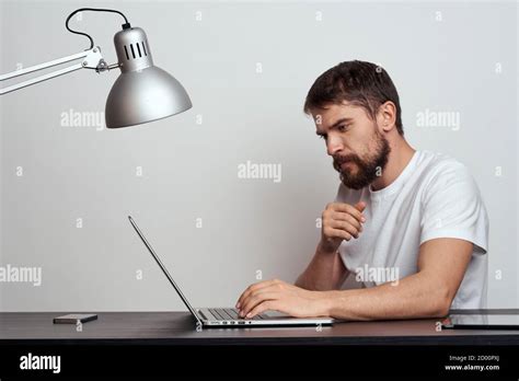 Business Man With Laptop At The Table Gestures With Hands Monitor